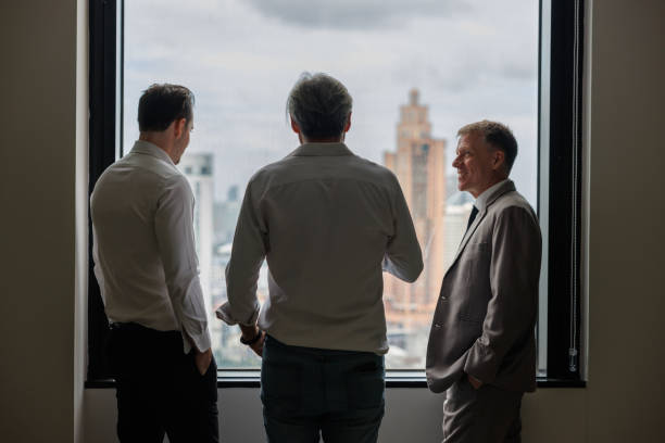 Free Stock Photo of Men Standing Together Near a Window | Download Free ...