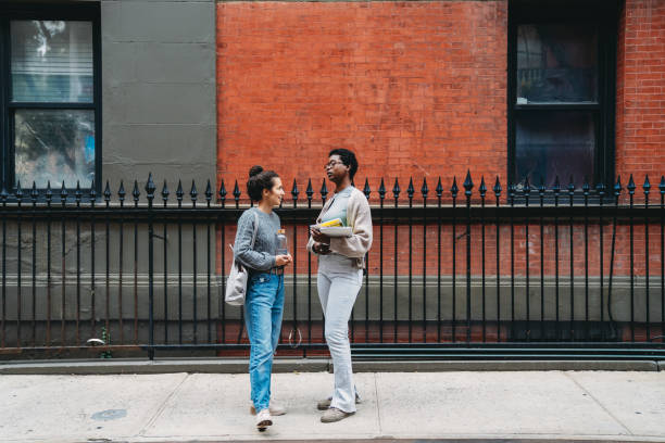 Free Stock Photo of Two People Standing Together on a Sidewalk ...