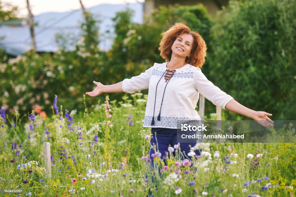 Outdoor Portrait Of Beautiful 50 Year Old Woman Enjoying Nice Day In