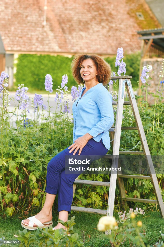 Outdoor Portrait Of Beautiful 50 Year Old Woman Enjoying Nice Day In