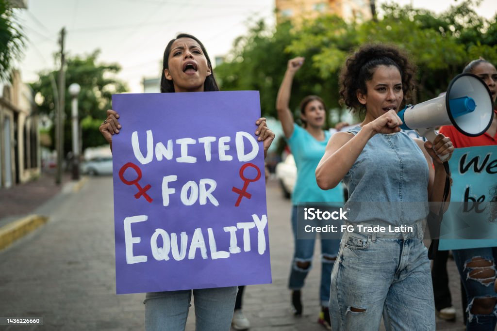 Young Protester Woman Holding Sign About Gender Equality On