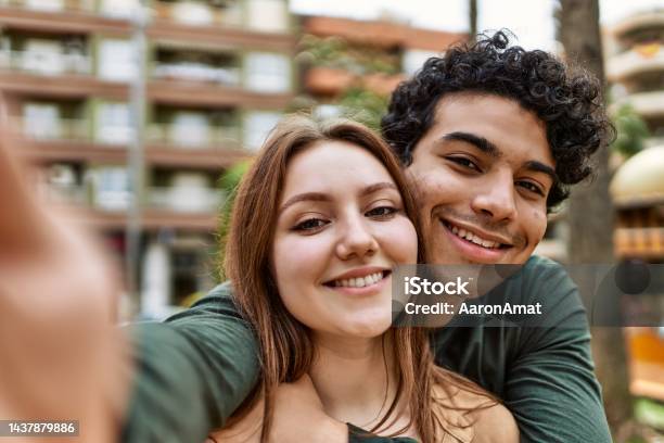 Young Interracial Couple Smiling Happy And Hugging Make Selfie By The