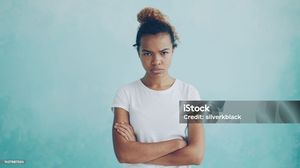 Portrait Of Angry African American Lady Looking At Camera Frowning And