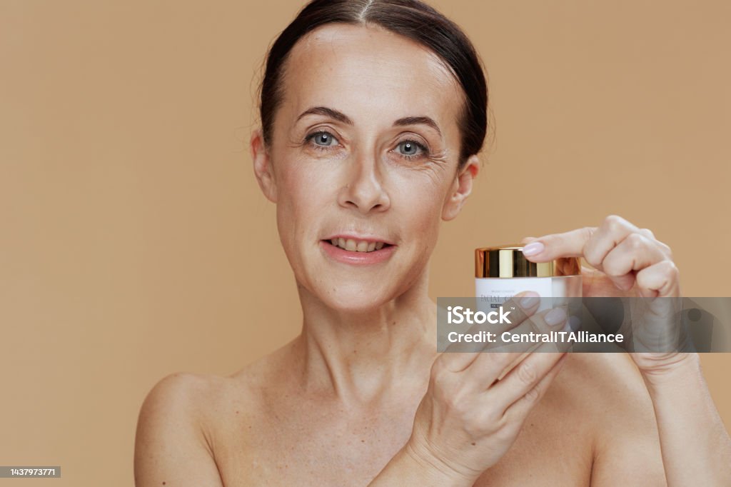 Portrait Of Happy Modern 40 Years Old Woman On Beige Background Stock