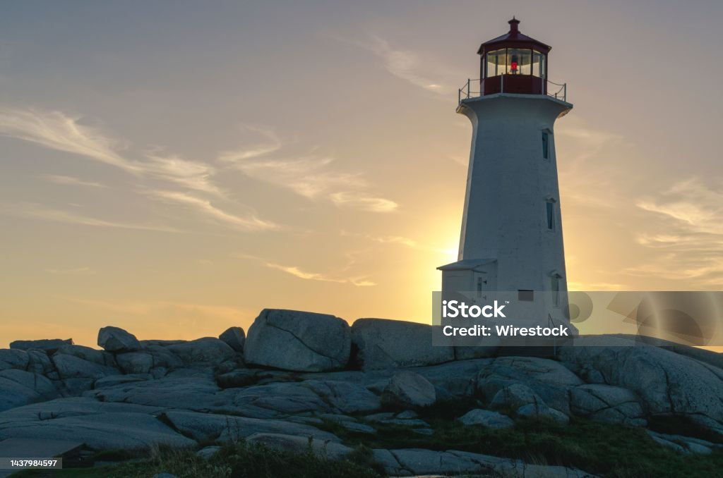 Peggys Point Lighthouse Against Yellow Sunset Sky Background Stock
