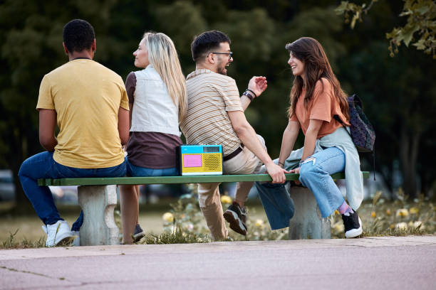 Free Stock Photo of Group of People Sitting on a Bench in a Courtyard ...