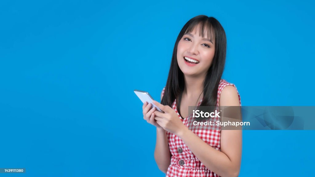 Beautiful Asian Woman Cute Girl Bangs Hair Style In Red Dress Playing A Smart Phone Isolated On