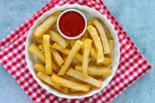 Closeup Image Of Fluted Dish Of Freshly Cooked Crispy Homemade French Fries Pile Of Salted