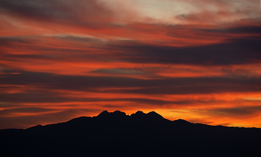 Sunrise Over Four Peaks In Silhouette Stock Photo - Download Image Now ... Sunrise Over Four Peaks In Silhouette Stock Photo - Download Image Now ...