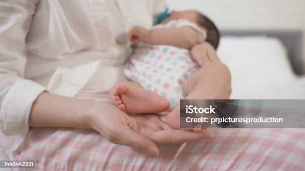 Selective Focus Shot A Pair Of Cute Little Feet Of The Newborn Infant Whos Sleeping Peacefully