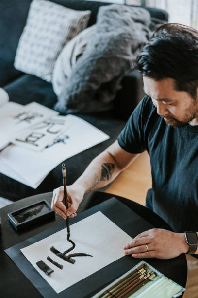 Free Stock Photo of Man writing calligraphy on a scroll with a quill ...