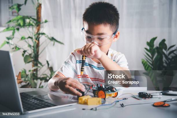Asian Kid Boy Assembling The Opensource Hardware And Software Robot Car ... Asian Kid Boy Assembling The Opensource Hardware And Software Robot Car ...