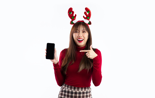 Young Asian Woman In Red Christmas Costume Wearing Reindeer Horns