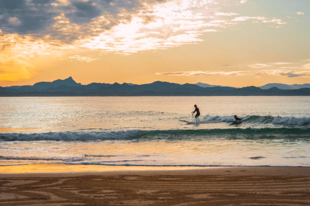 Free Stock Photo of Person Riding Surfboard in Ocean at Sunset ...