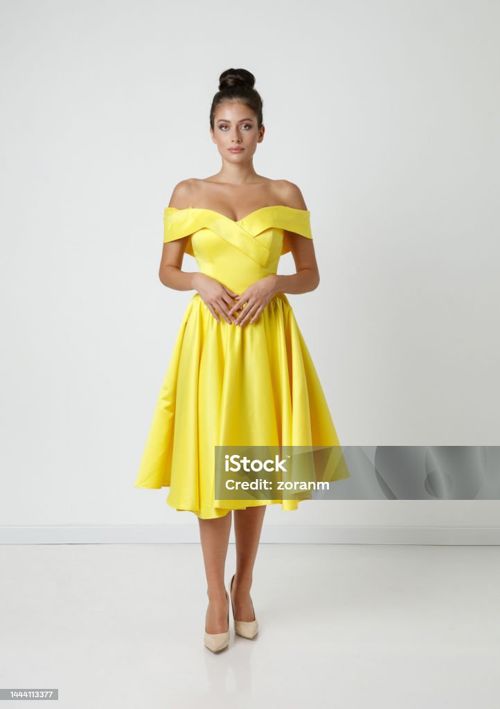 Beautiful Fashion Model In Yellow Dress Off Shoulder Looking At Camera