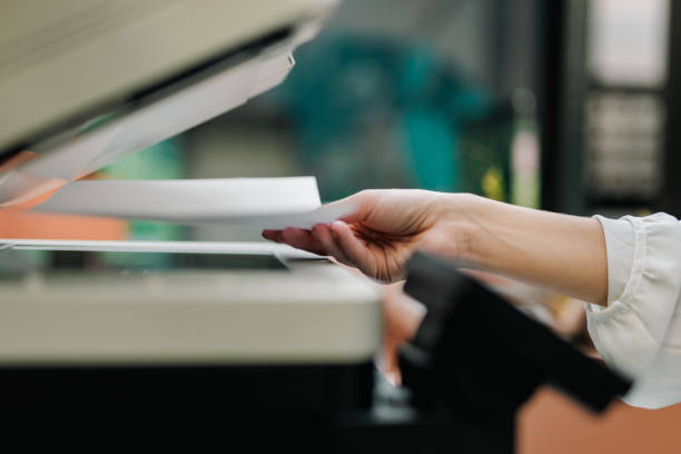 Free Stock Photo of Hands holding printed papers over a printer ...