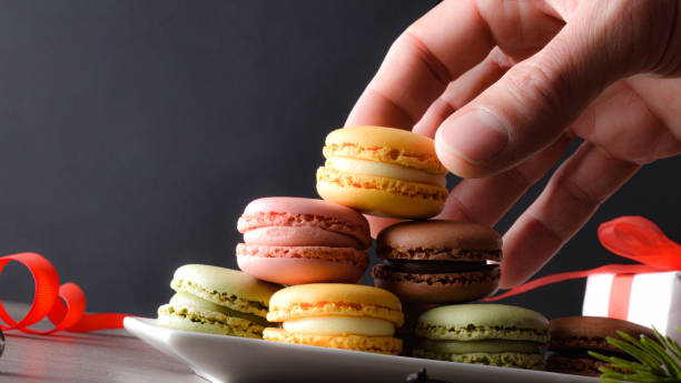 Free Stock Photo of Hand reaching for a basket of macarons | Download ...