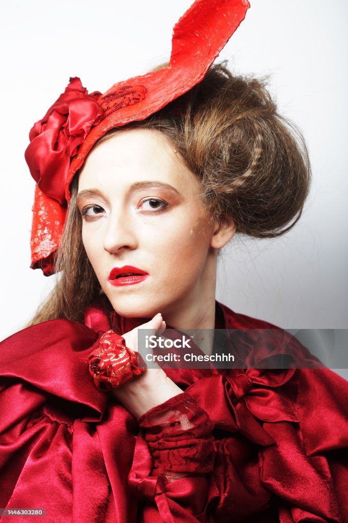 Young Beautiful Woman In A Red Lace Suit And Hat A Stylish Blonde In