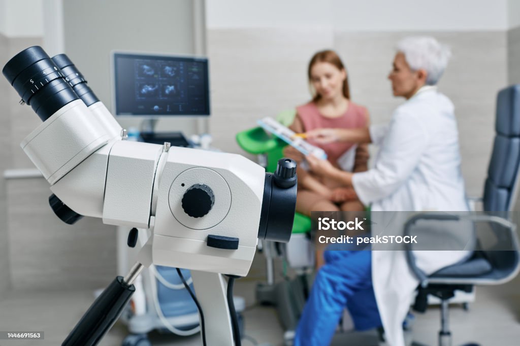 Closeup Of Colposcope Over Background Gynecological Consultation Of Woman Patient With Doctor