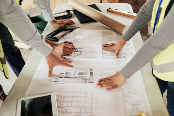 Free Stock Photo of Engineers planning over a blueprint at work ...
