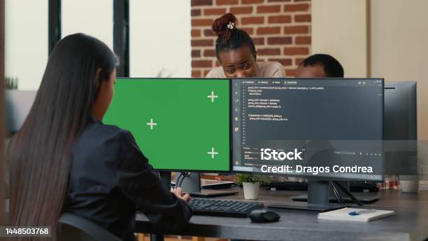 Software Developer Writing Algorithm In Front Of Computer With Green
