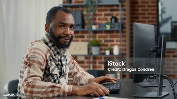 Portrait Of Programer Typing Programming Code On Computer Keyboard Turning Head And Smiling