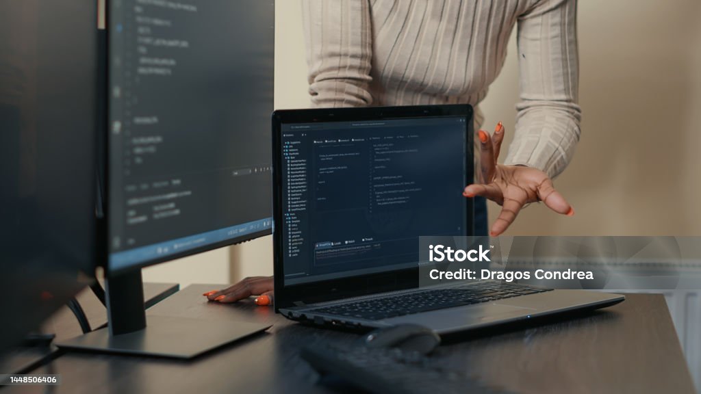 Closeup Of Laptop Running Algorithm Parsing Code On Desk In Front Of Programmers Doing Team Work