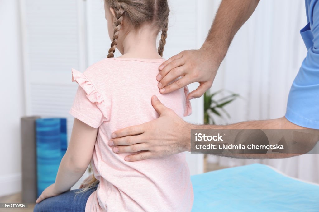 Orthopedist Examining Childs Back In Clinic Closeup Scoliosis Treatment ... Orthopedist Examining Childs Back In Clinic Closeup Scoliosis Treatment ...
