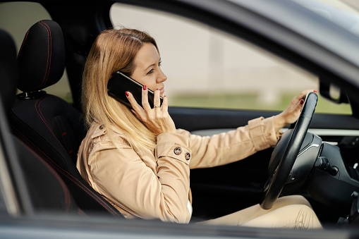 An Irresponsible Woman Is Driving Her Car While Having A Phone Call ... An Irresponsible Woman Is Driving Her Car While Having A Phone Call ...