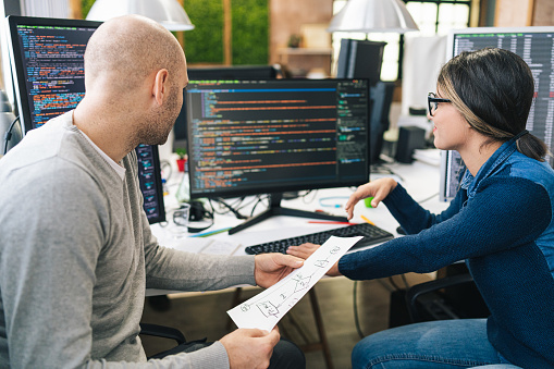Software Programmers Analyzing Html Code And Database Brainstorming Script Ideas To Develop New