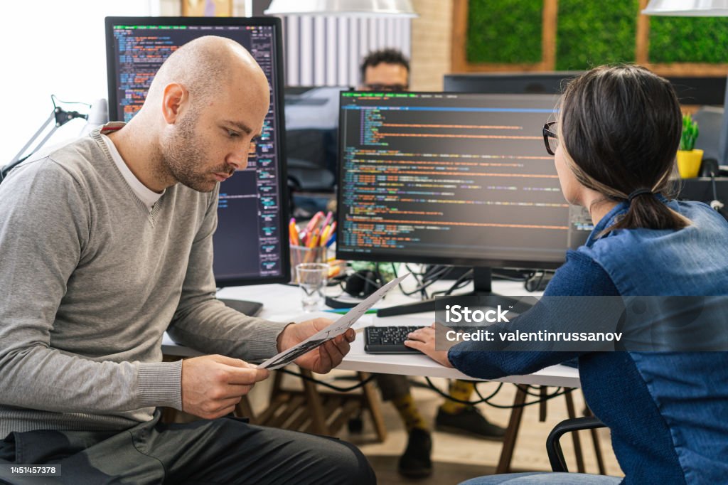 Software Programmers Analyzing Html Code And Database Brainstorming