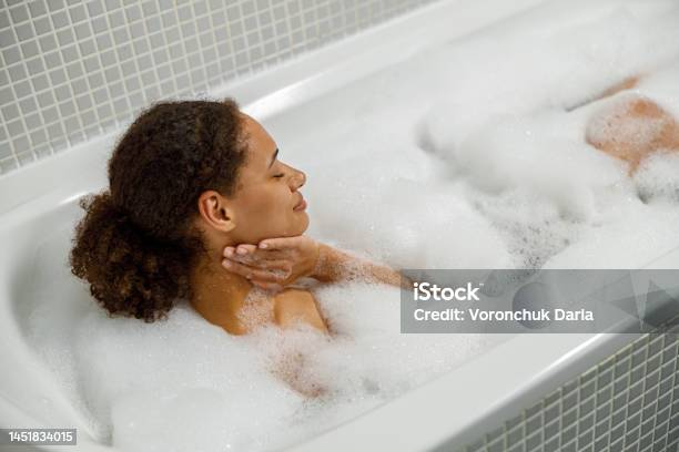 Beautiful Afro American Woman Takes Bubble Bath In Bathtub Spa Wellness