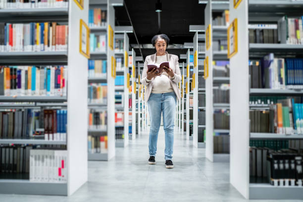 Free Stock Photo of Person Walking Down Long Aisle of Books | Download ...