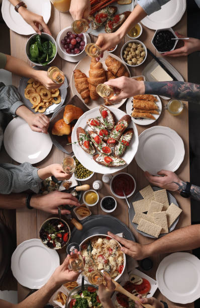 Free Stock Photo of Group of People Sitting Around Table Eating Food ...