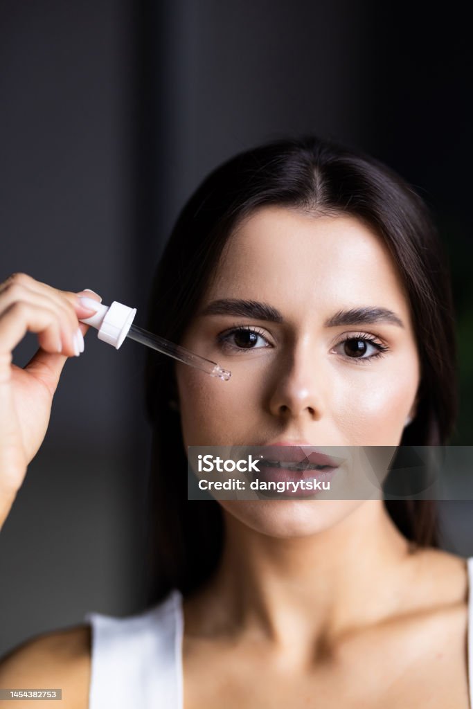 Portrait Of Young Woman Applying Hyaluronic Acid At Home Skin Care