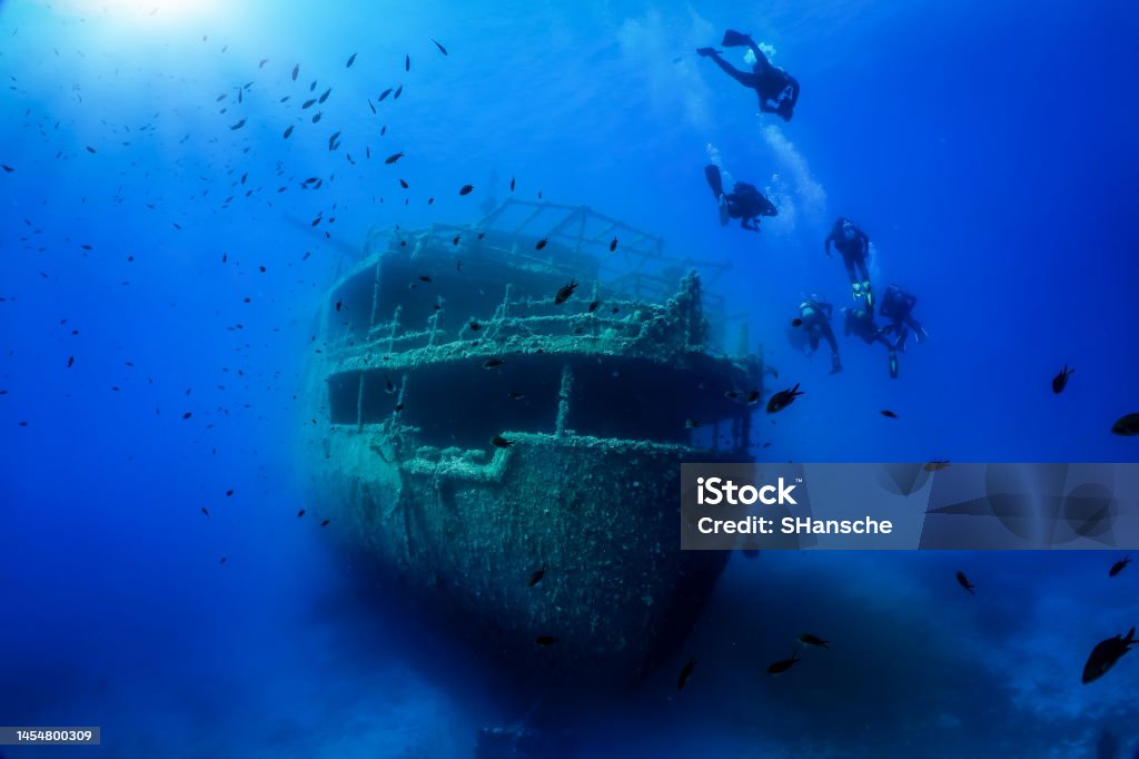 A Group Of Unrecognizable Divers Explore A Sunken Shipwreck Stock Photo ... A Group Of Unrecognizable Divers Explore A Sunken Shipwreck Stock Photo ...