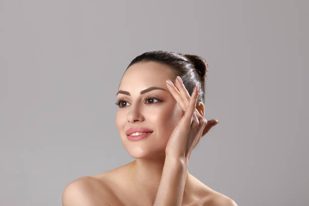 150 Young Beautician Applying Lip Balm On Beautiful Woman Fotos De