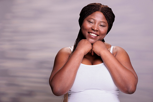 African American Body Positive Woman Holding Hands Under Chin Stock