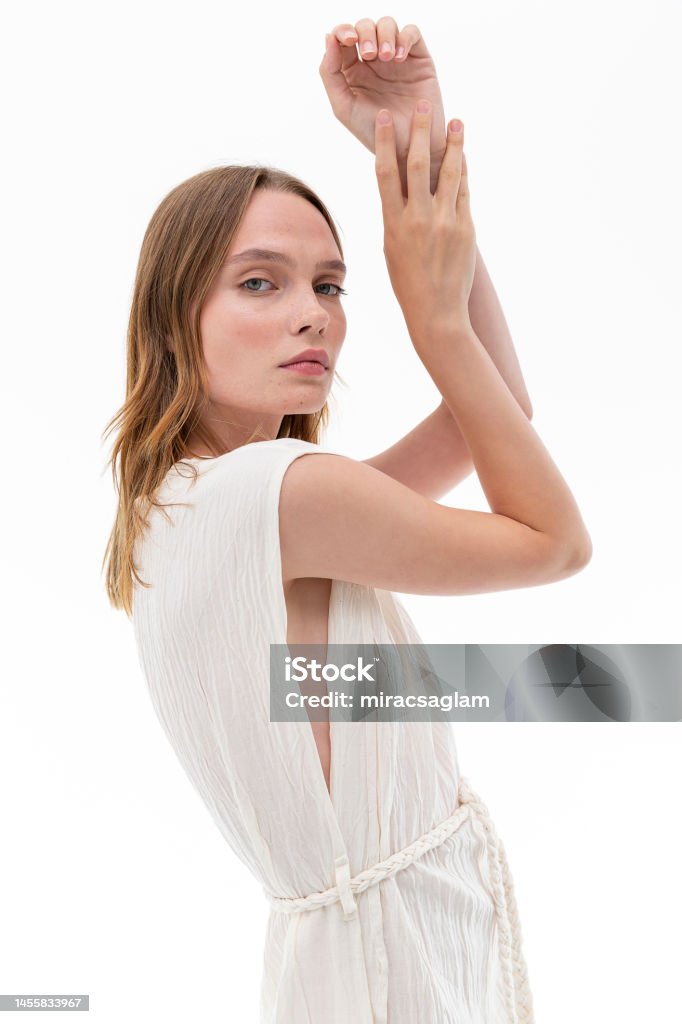 Blonde Freckled Girl On A White Background Wearing A Silk Or Linen