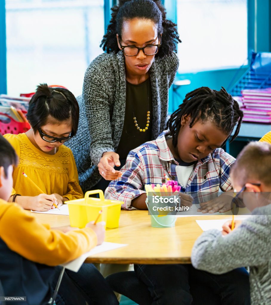 Teacher Helping Elementary Students Writing In Class Stock Photo ... Teacher Helping Elementary Students Writing In Class Stock Photo ...