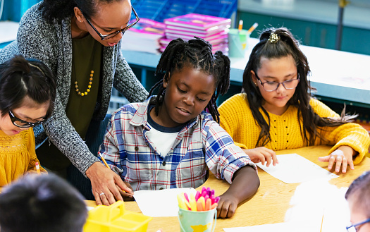 Teacher Helping Elementary Students Writing In Class Stock Photo ... Teacher Helping Elementary Students Writing In Class Stock Photo ...