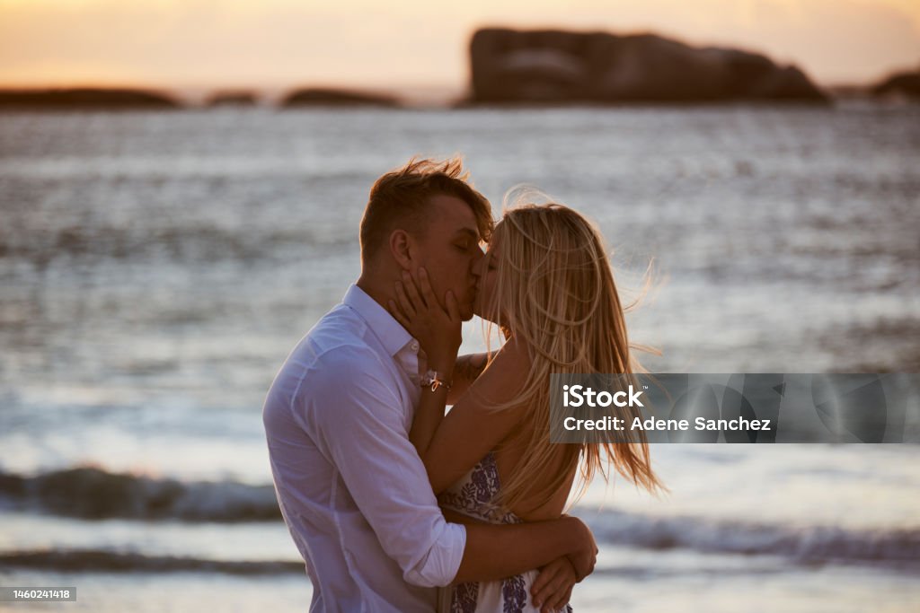 Ocean Sunset And Beach Couple Kiss Hug Or Enjoy Outdoor Quality Time Together On Relax Romantic