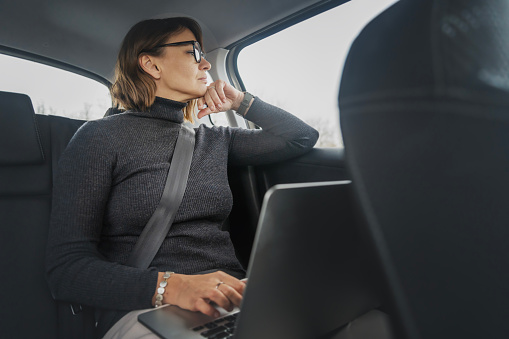 Adult Aattractive Caucasian Businesswoman Using Laptop While Sitting On