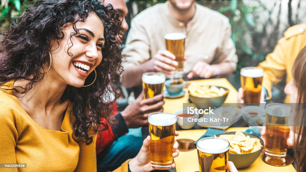 Happy Friends Cheering Beer Glasses At Brewery Pub Restaurant Group Of