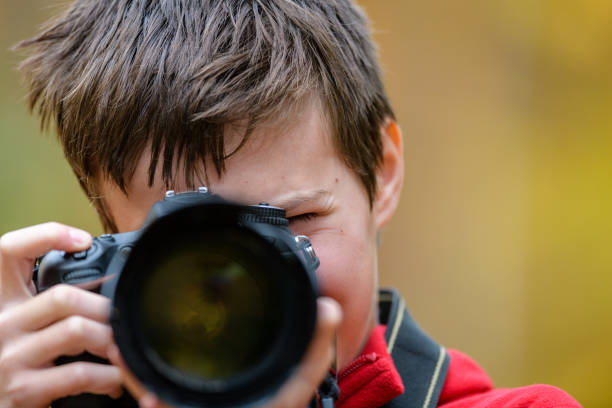 Free Stock Photo of Young Boy Looking Through a Camera Lens | Download ...