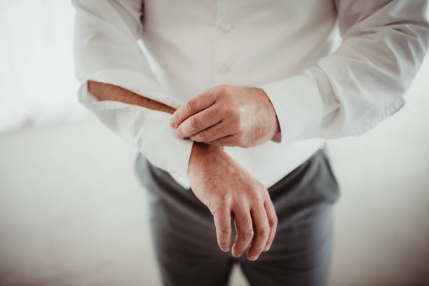 Free Stock Photo of Close-up of a man buttoning a white shirt ...