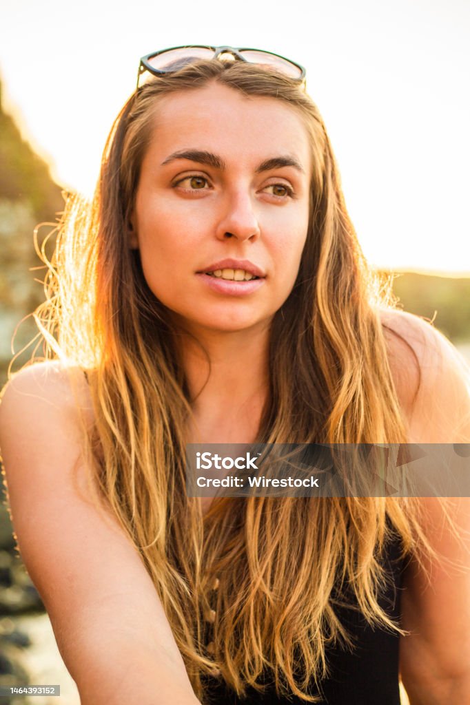 Beautiful Young Female With Long Blonde Hair Wearing Black Swimwear On