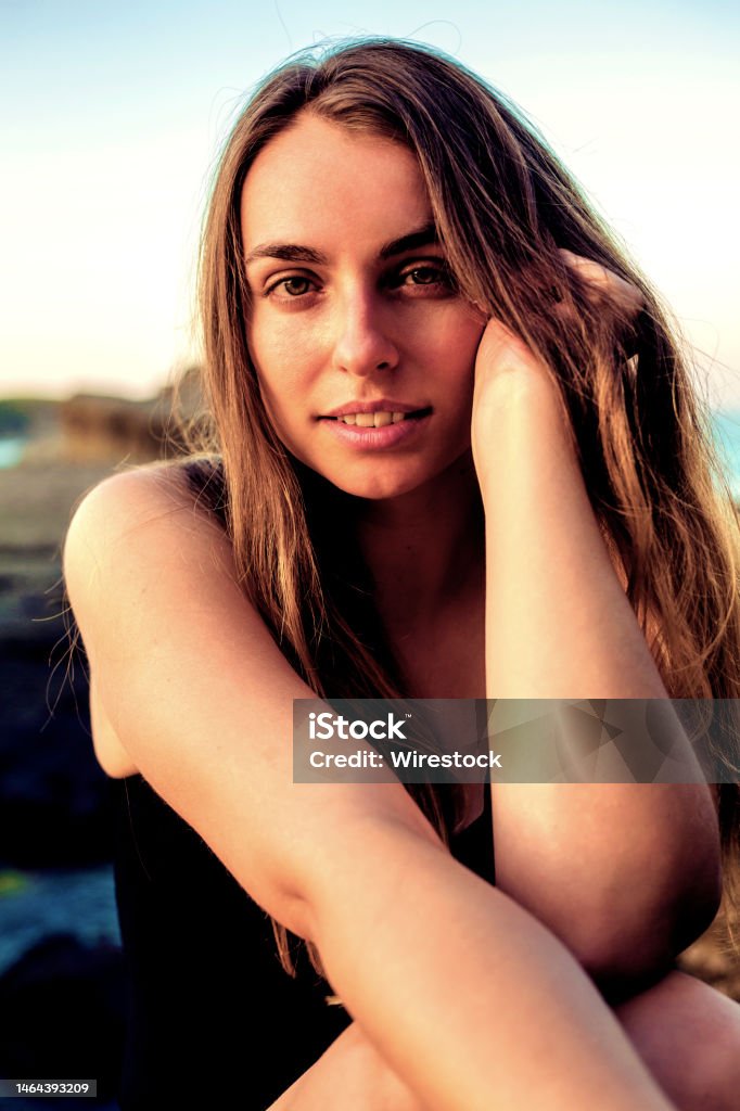 Beautiful Young Female With Long Blonde Hair Wearing Black Swimwear On