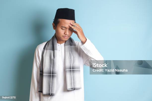 Asian Muslim Man Having A Migraine Touching His Temple Stock Photo ... Asian Muslim Man Having A Migraine Touching His Temple Stock Photo ...