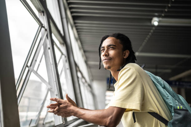 Free Stock Photo of Man Observing Space Through Window in Station ...
